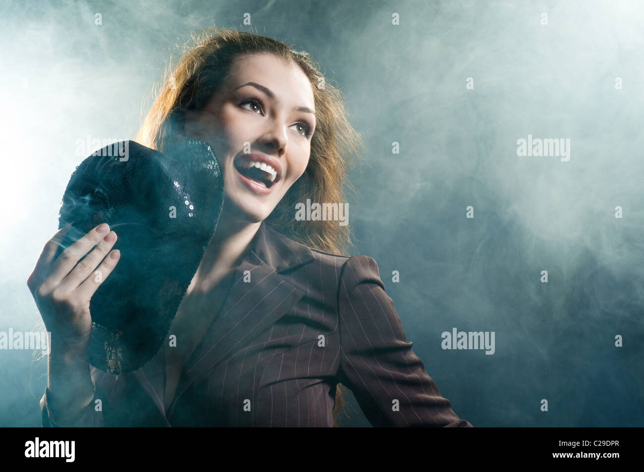 girl in the smoke enlightened with spotlights Stock Photo - Alamy