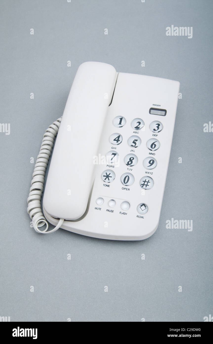 White office phone on the flat surface Stock Photo - Alamy