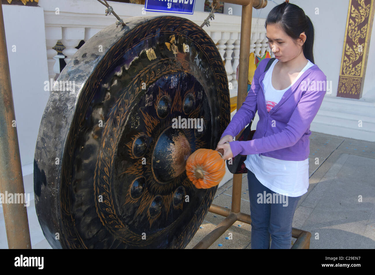 Thai woman hitting a gong at Wat Phra That Si Chom Tong Temple in ...