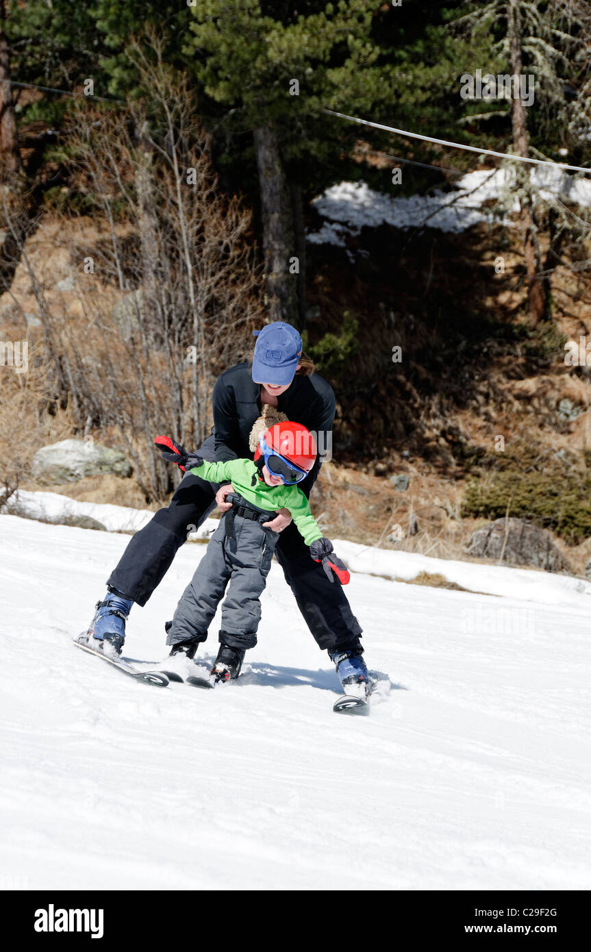 A young boy learning to ski on snow Stock Photo - Alamy