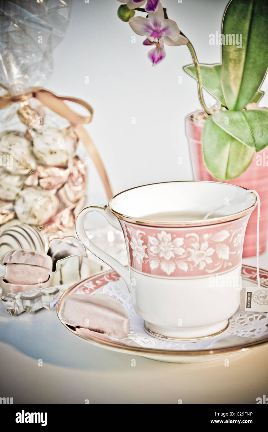 Classy porcelain cup of tea and chocolates - vintage abstract look ...