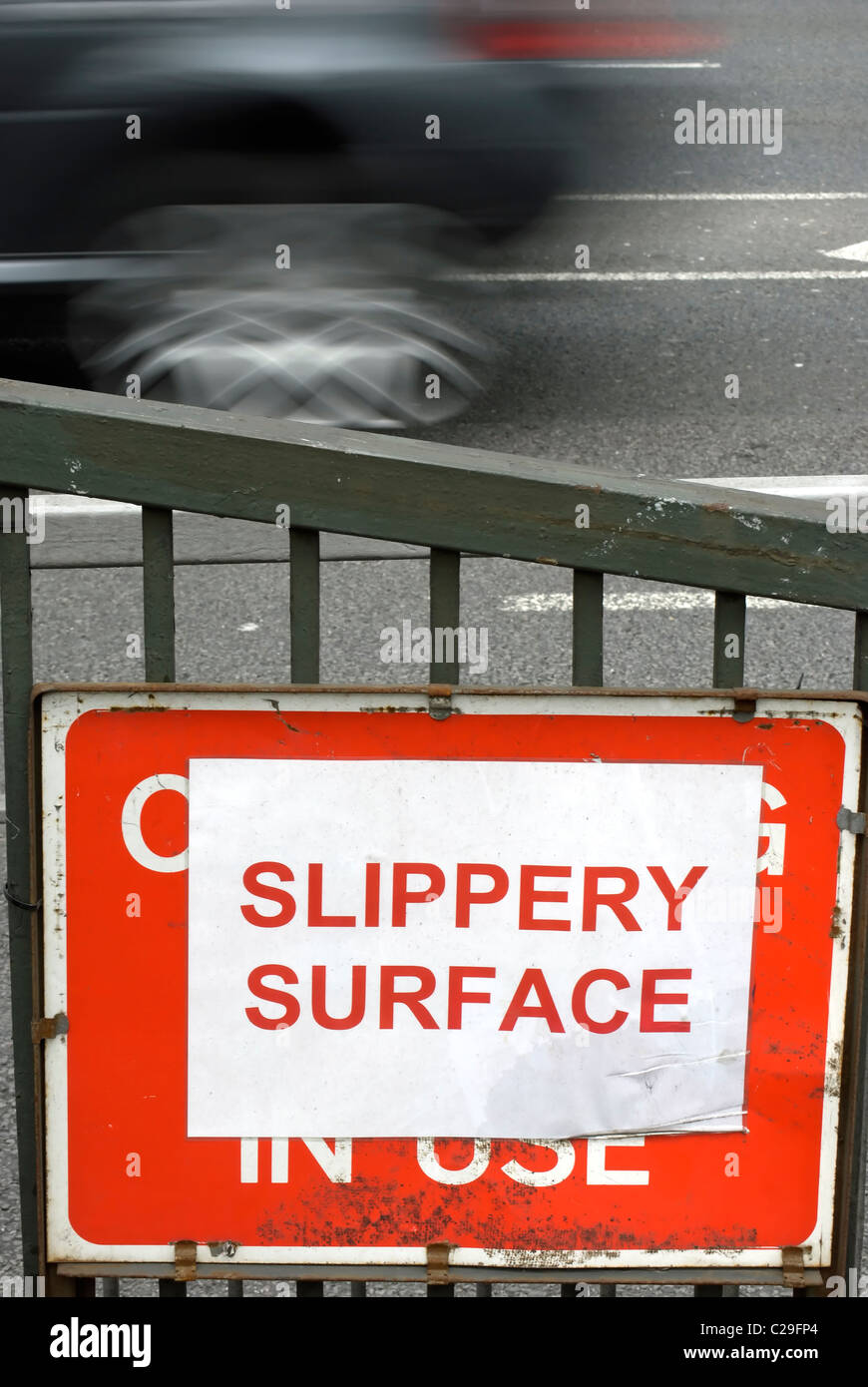 slippery surface sign beside a road in richmond upon thames, surrey ...