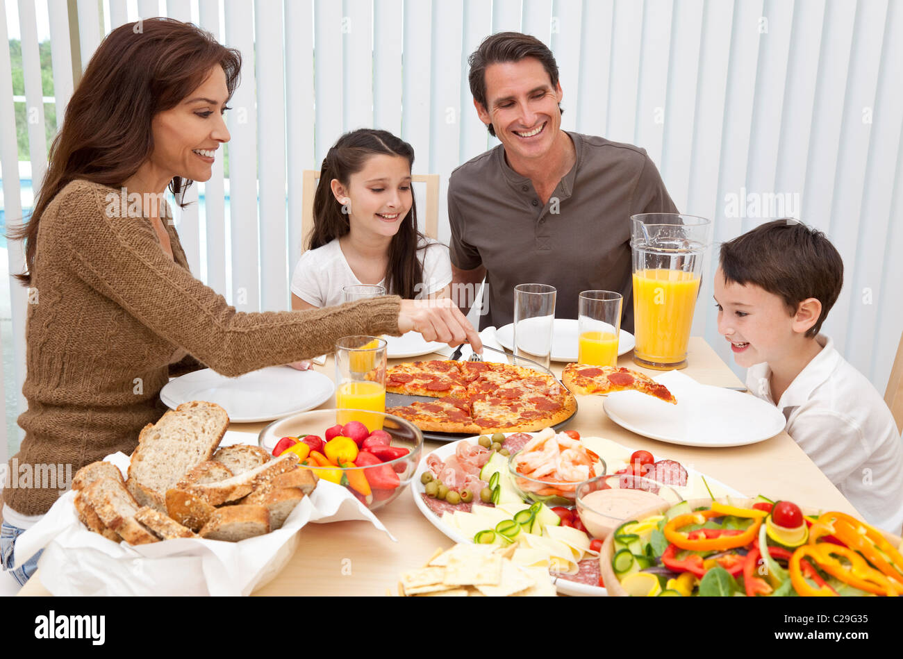 An attractive happy, smiling family of mother, father, son and daughter ...