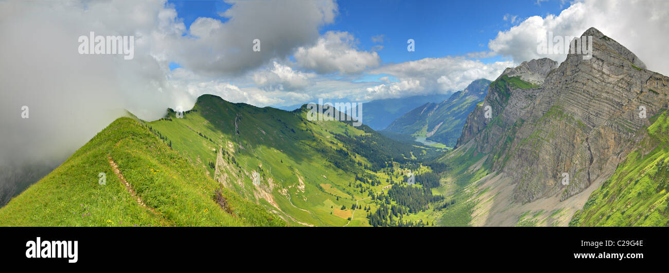 panorama of a mountain valley formed by two steep ridges with ...
