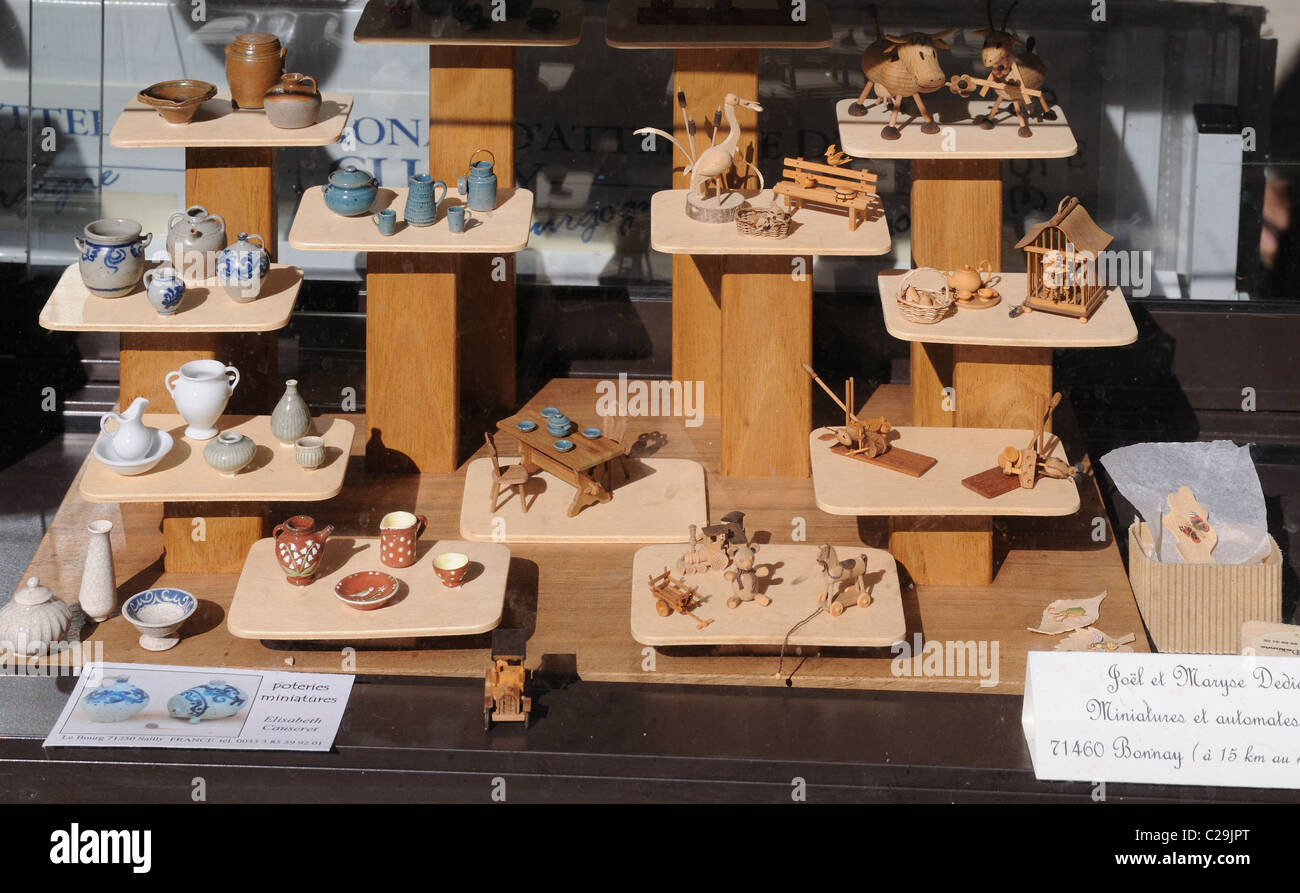 Shop window of tiny miniatures including pottery furniture and animals ...