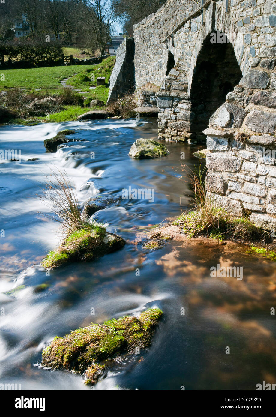Granite built stone bridge at Postbridge on Dartmoor using slow shutter ...