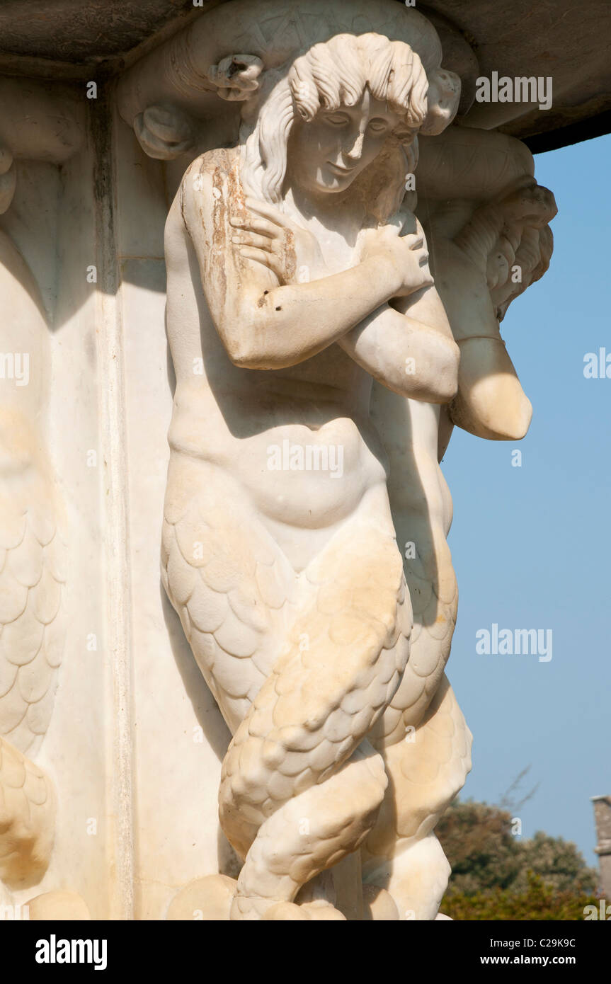 Marble statue of mermaids supporting a fountain in the Italian garden ...