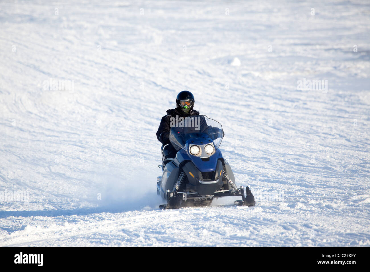 A snowmobile isolated against a winter snow landscape Stock Photo - Alamy