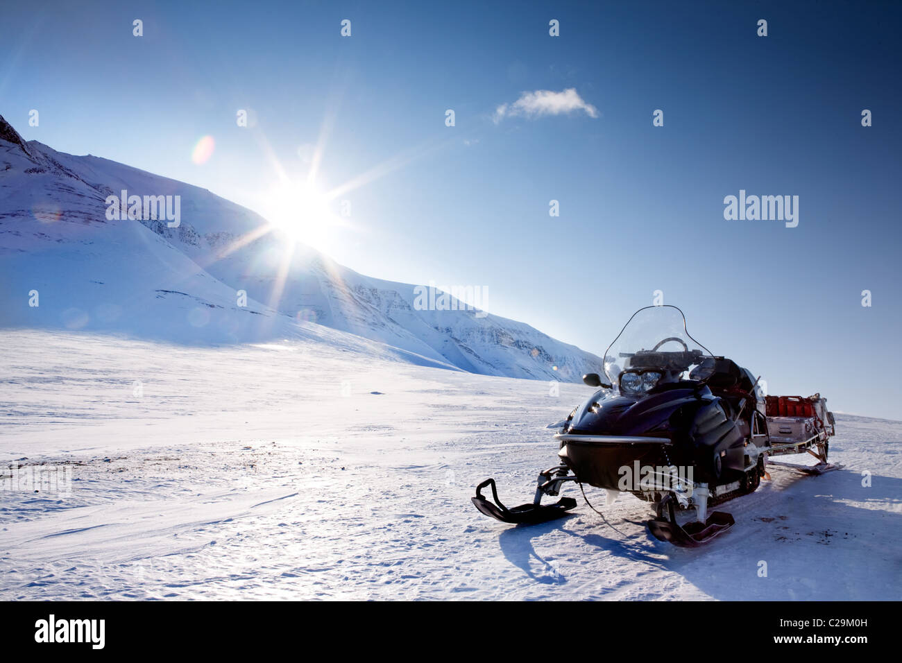 A snowmobile in a winter mountain landscape Stock Photo - Alamy