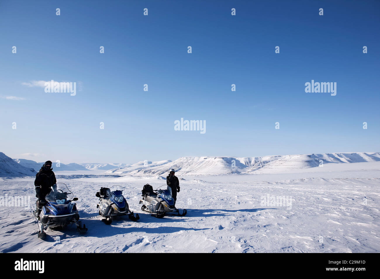 A group of people on a snowmobile trip in a winter landscape Stock ...
