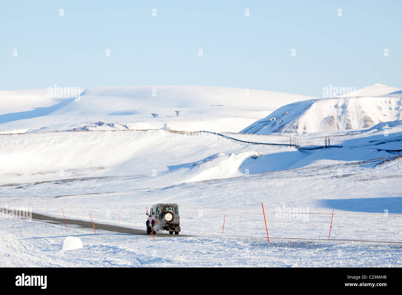 A truck driving on a barren landscape of snow and ice - Svalbard ...