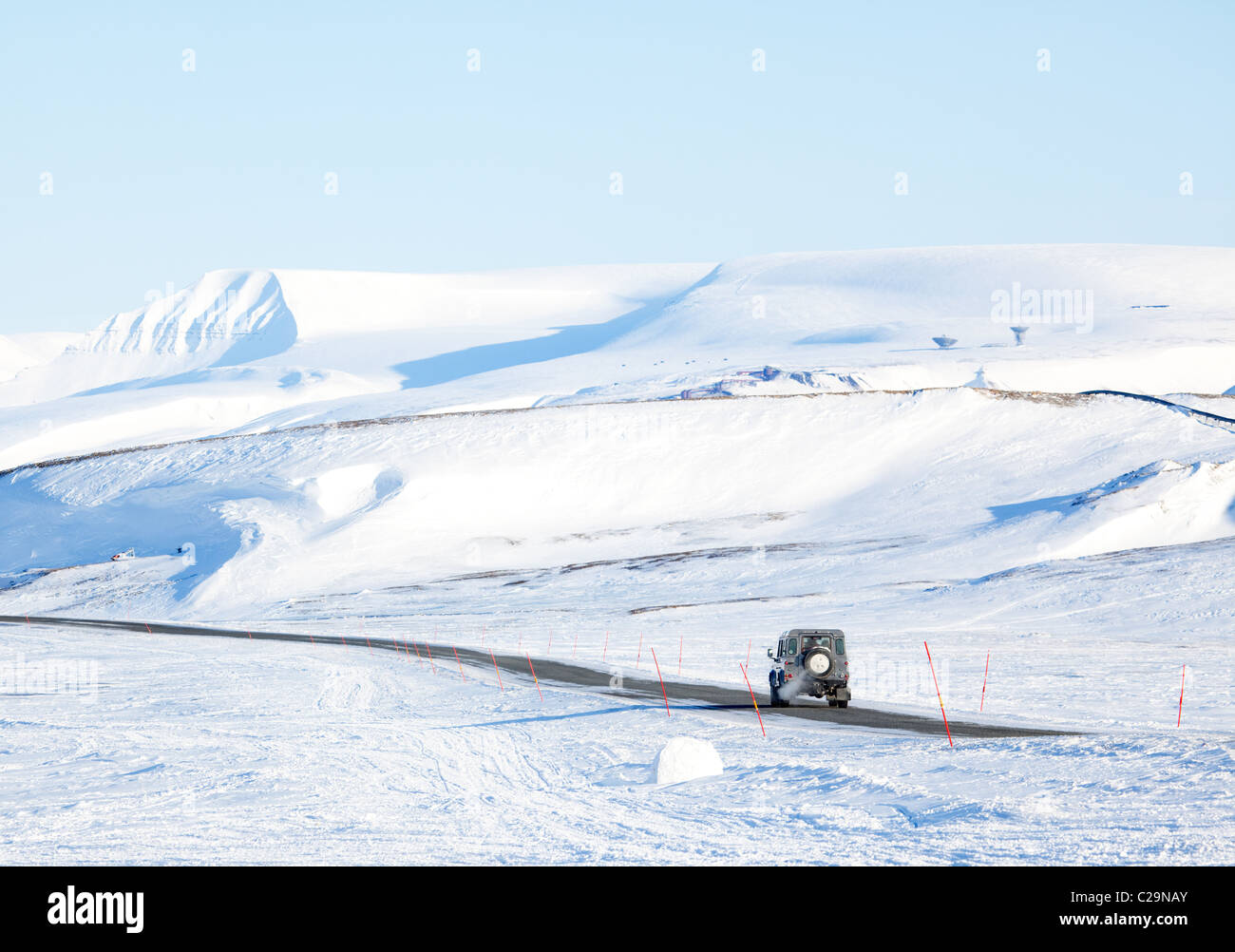 A truck driving on a barren landscape of snow and ice - Svalbard ...
