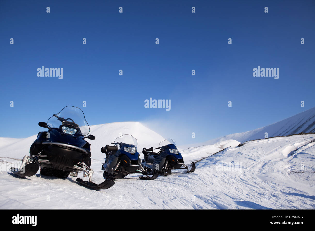 Three snowmobiles on an outdoor winter landscape Stock Photo - Alamy