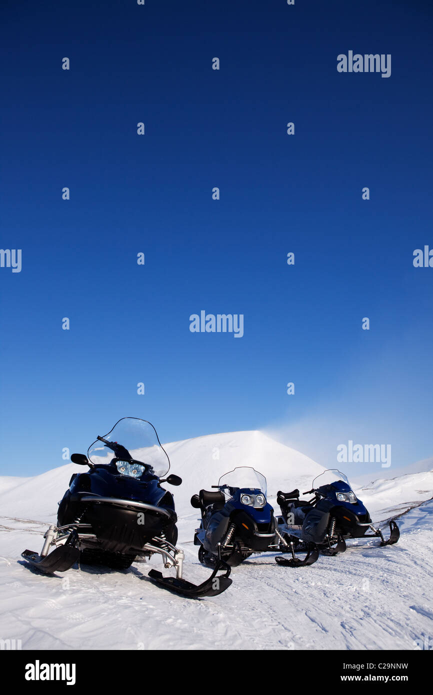Three snowmobiles on an outdoor winter landscape Stock Photo - Alamy