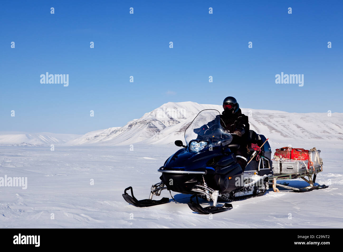 A snowmobile on an arctic expedition on a frozen lake Stock Photo - Alamy