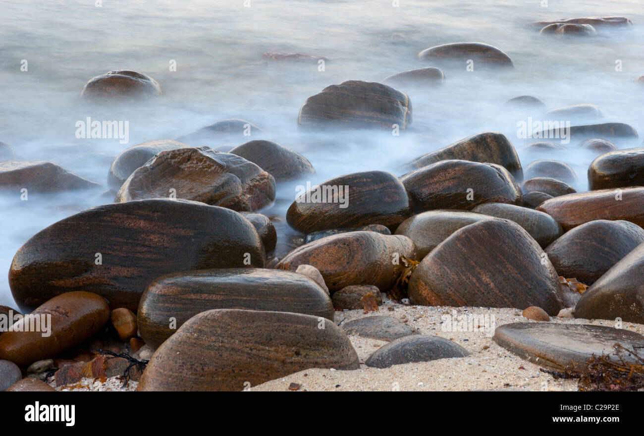Weathered rocks on a beach Stock Photo - Alamy