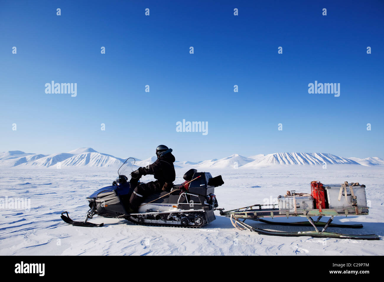 A snowmobile on an arctic expedition on a frozen lake Stock Photo - Alamy