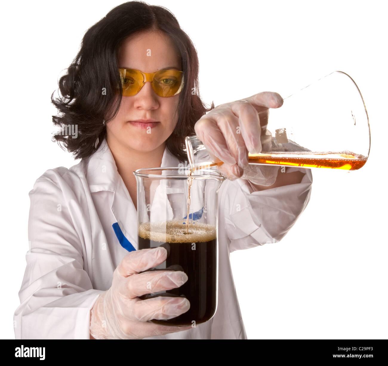 Young lab worker mixing two liquids Stock Photo - Alamy