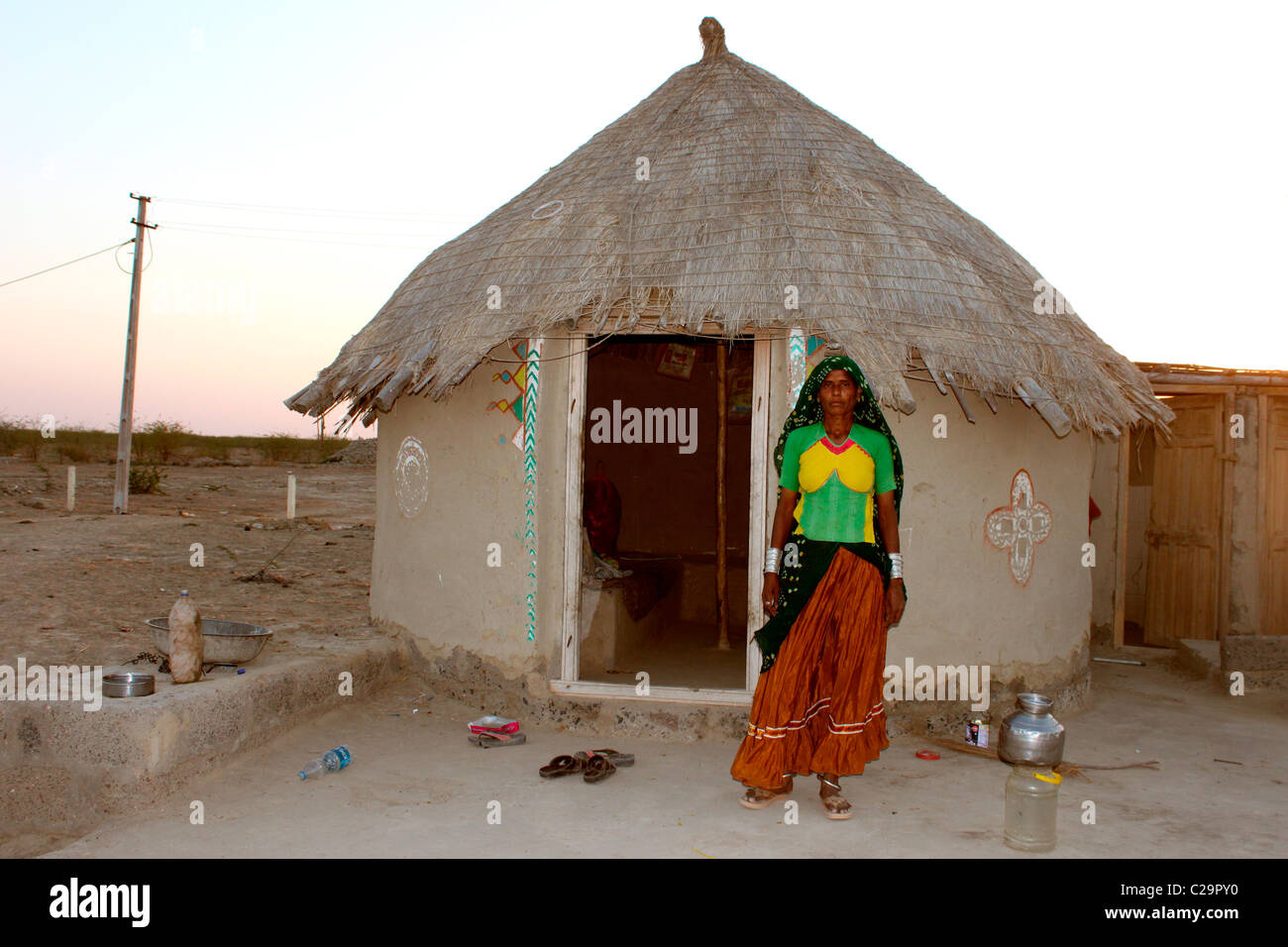 A rural woman standing in front of hut in Kutch, Gujarat, India Stock ...