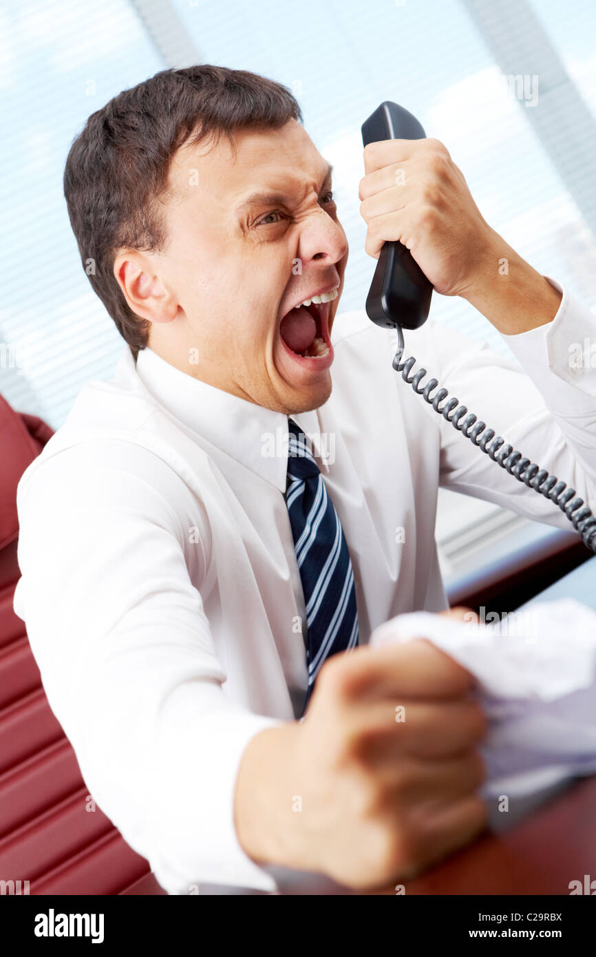 An angry manager screaming in telephone receiver Stock Photo - Alamy