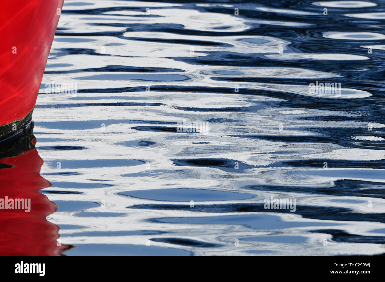 Reflection of a boat hull and patterns in water Stock Photo - Alamy