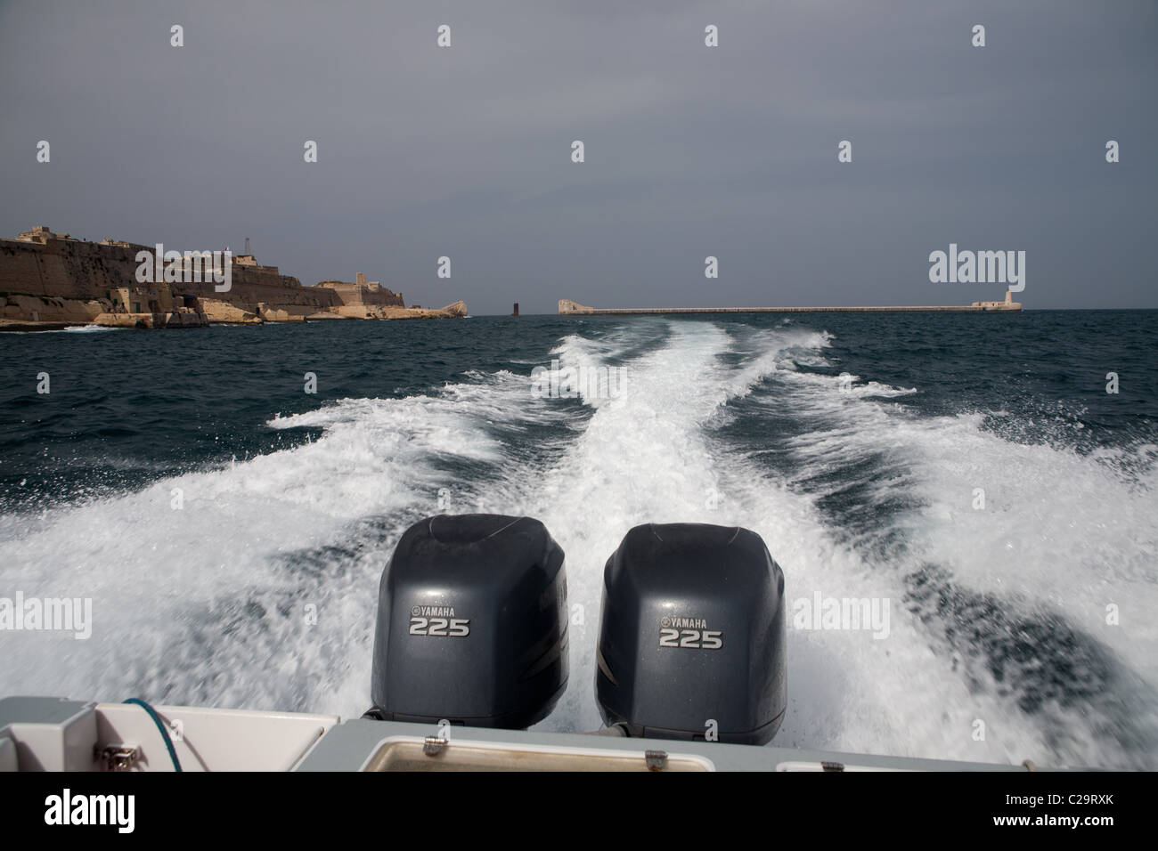 A Speed Boat with twin Yamaha 225 outboard engines creating a wake ...