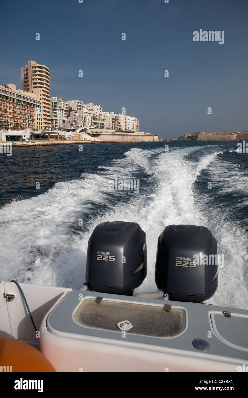 A Speed Boat with twin Yamaha 225 outboard engines creating a wake ...