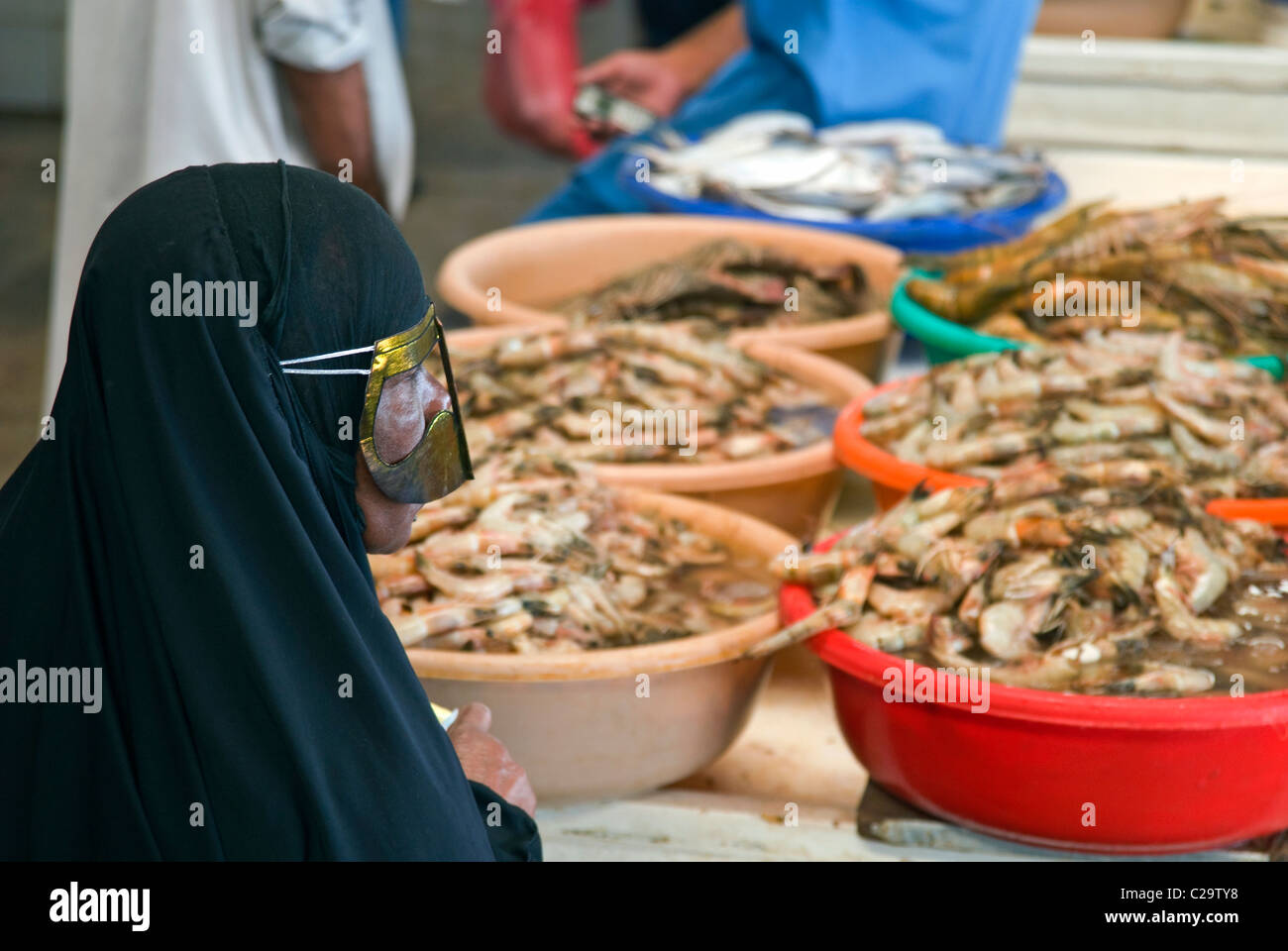 Veiled arab woman at Fish Market, Dubai, United Arab Emirates, Middle ...