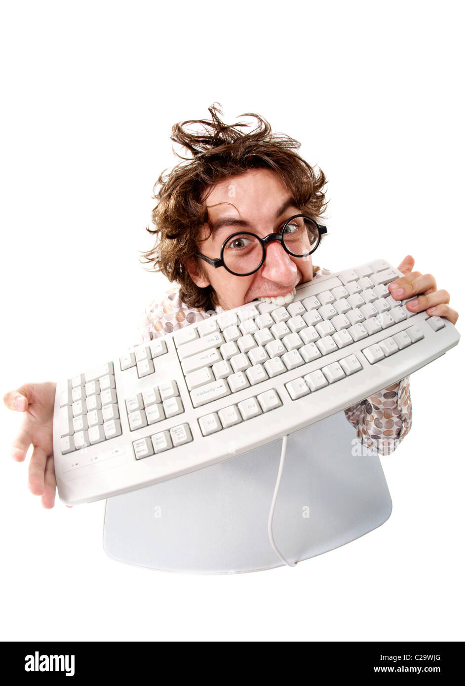 High angle view of a tousled man biting keyboard Stock Photo - Alamy