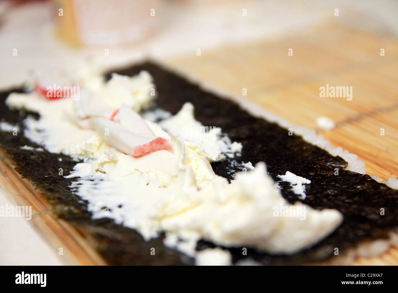 Process of making roll on wooden mat, closeup Stock Photo - Alamy
