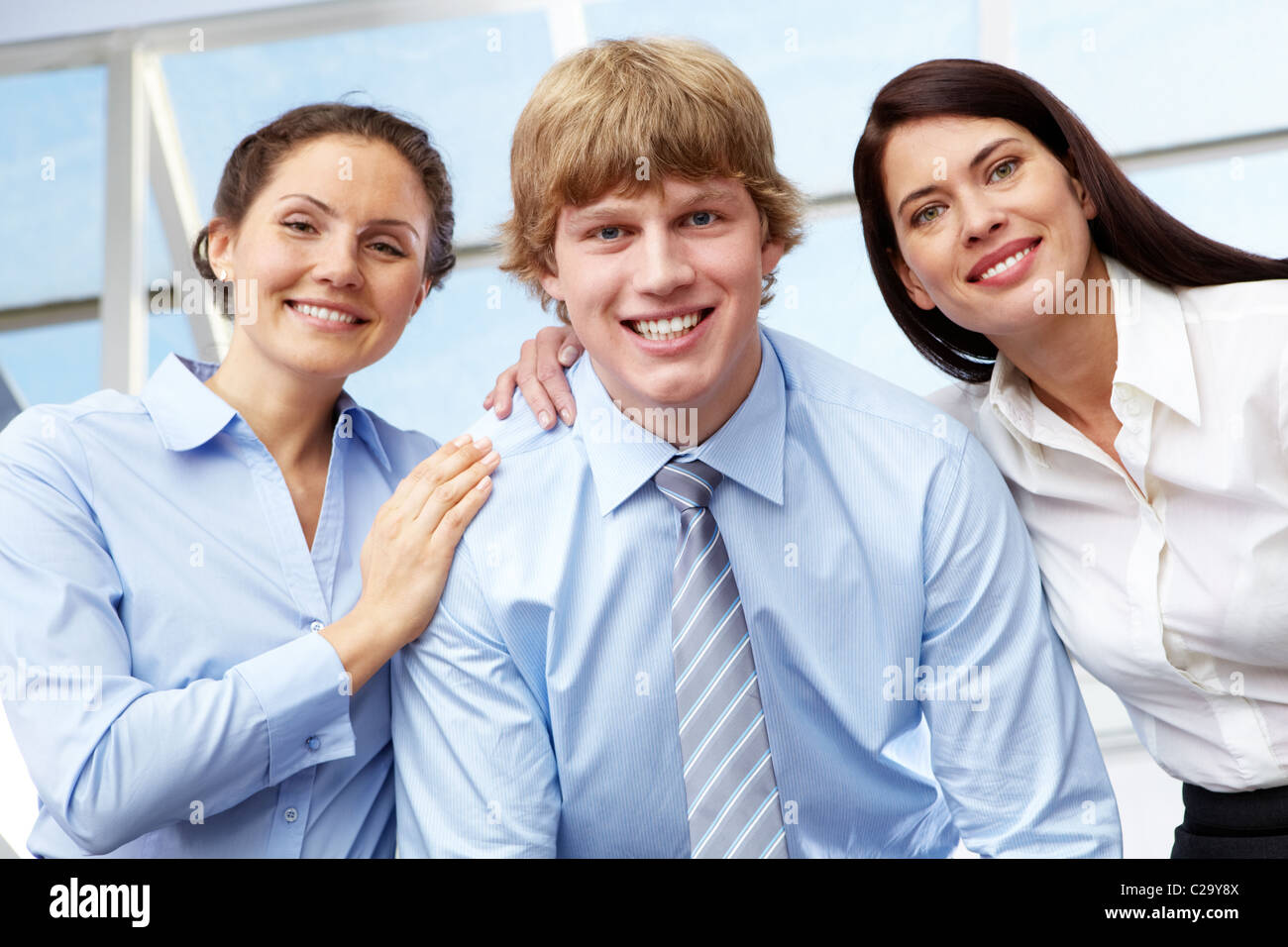 Portrait of friendly three business people looking at camera Stock ...