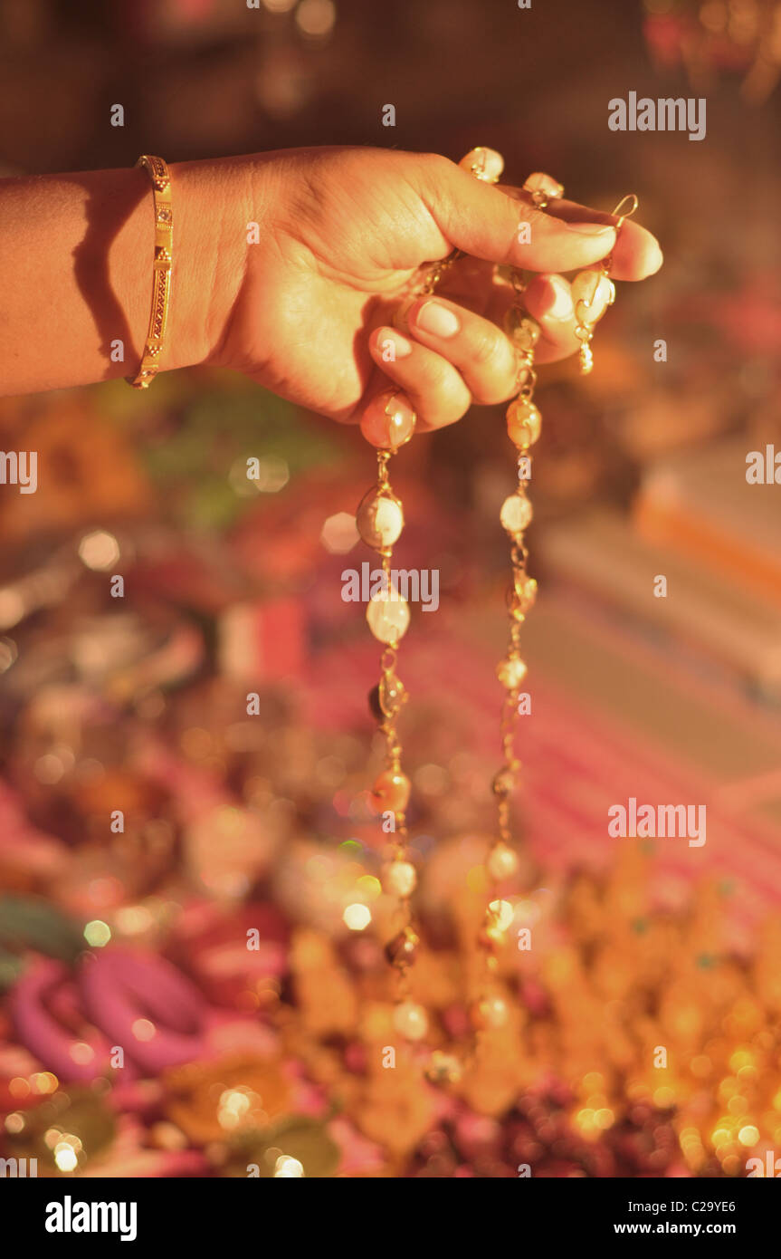 A hand displaying Necklace Stock Photo - Alamy
