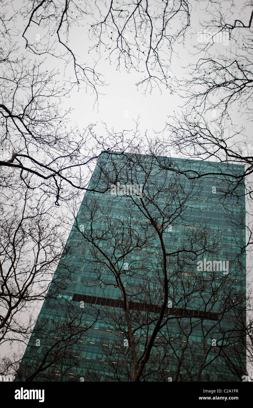 Looking up at a dull glass office building from Bryant Park in ...