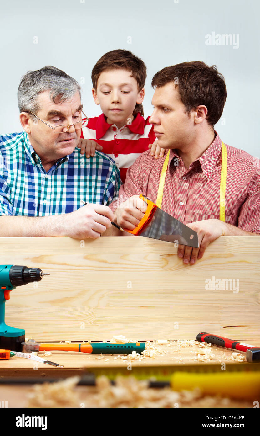 Family of men working with diy tools Stock Photo - Alamy