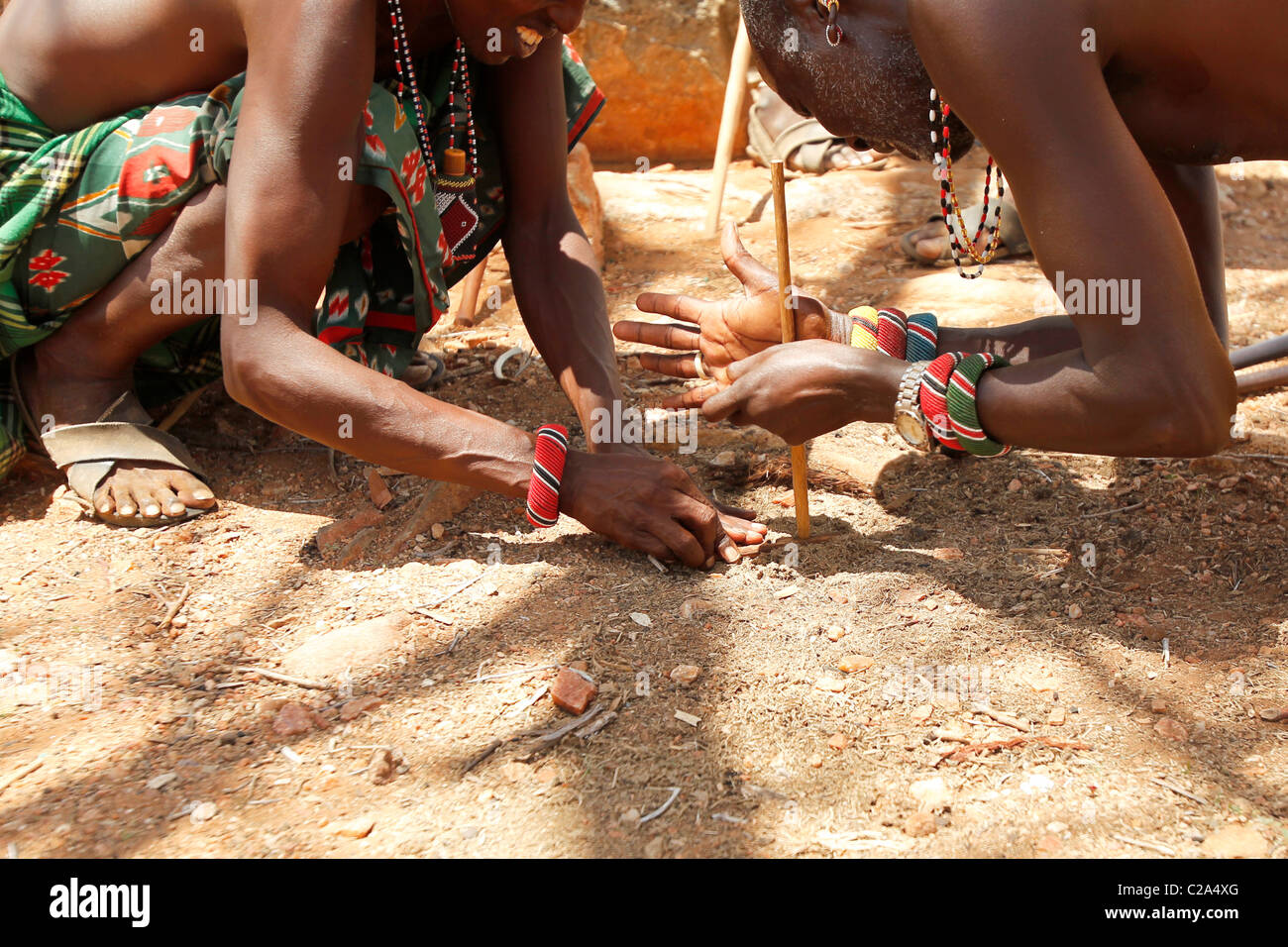 A samburu tribesman making fire with two sticks Stock Photo - Alamy