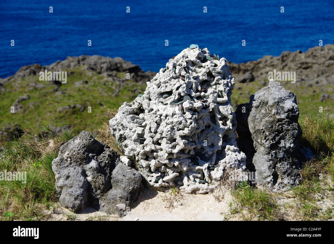 Local shrine made of coral with coins as offering next to Kuburabari on ...