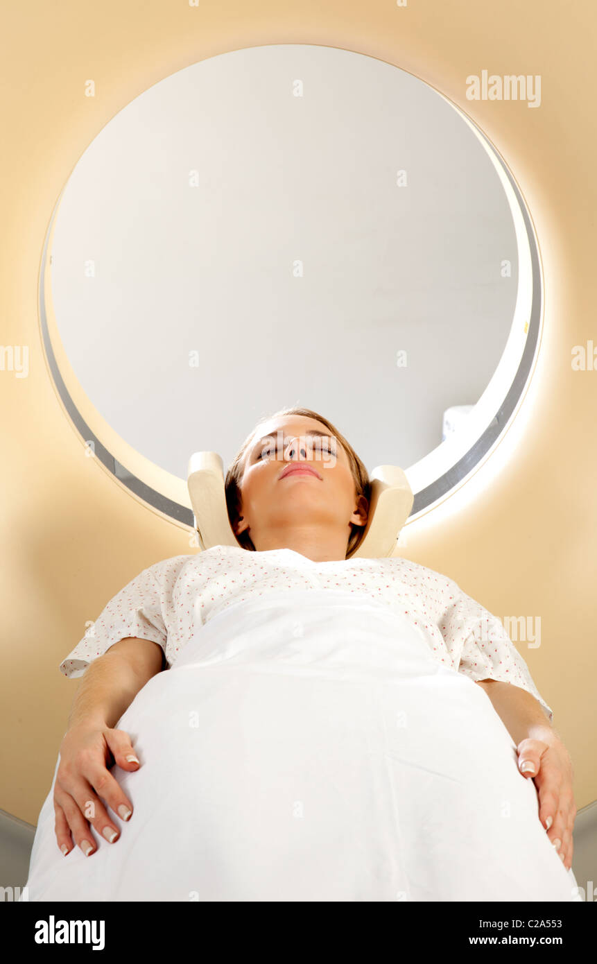 A young woman taking a CT scan - screening test Stock Photo - Alamy