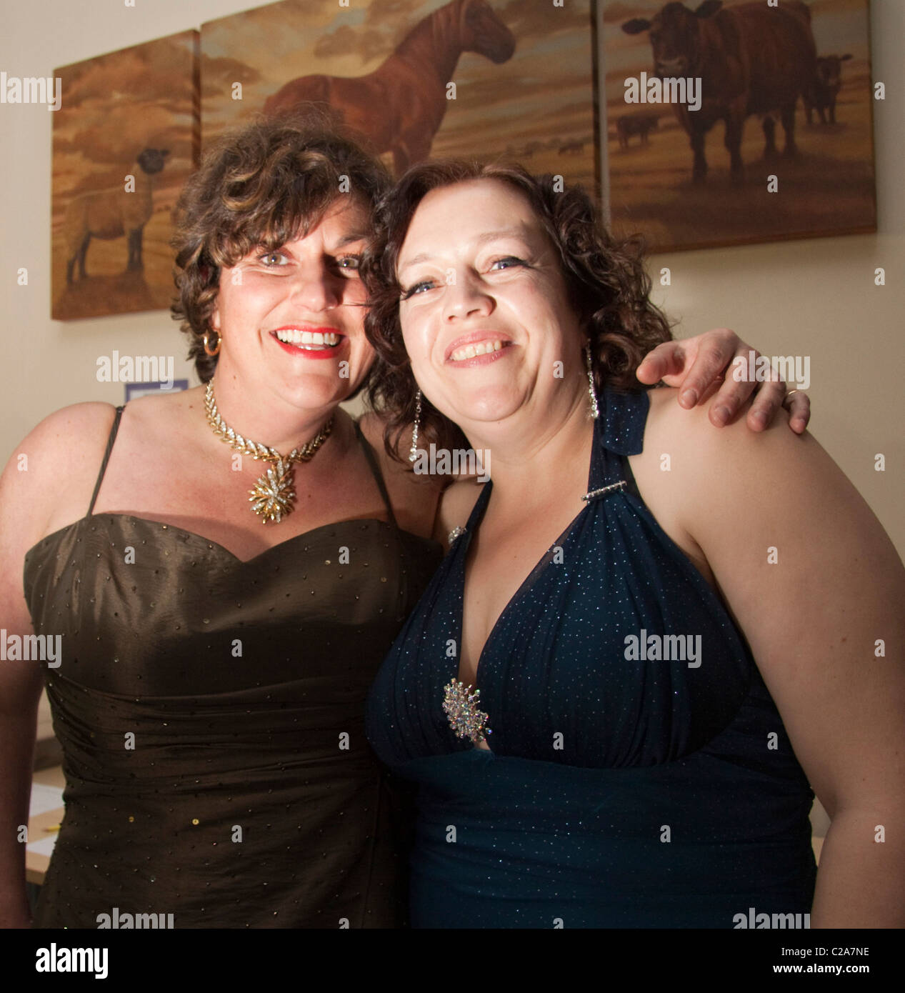 Two ladies in evening dress before a triptych of the Suffolk trinity ...