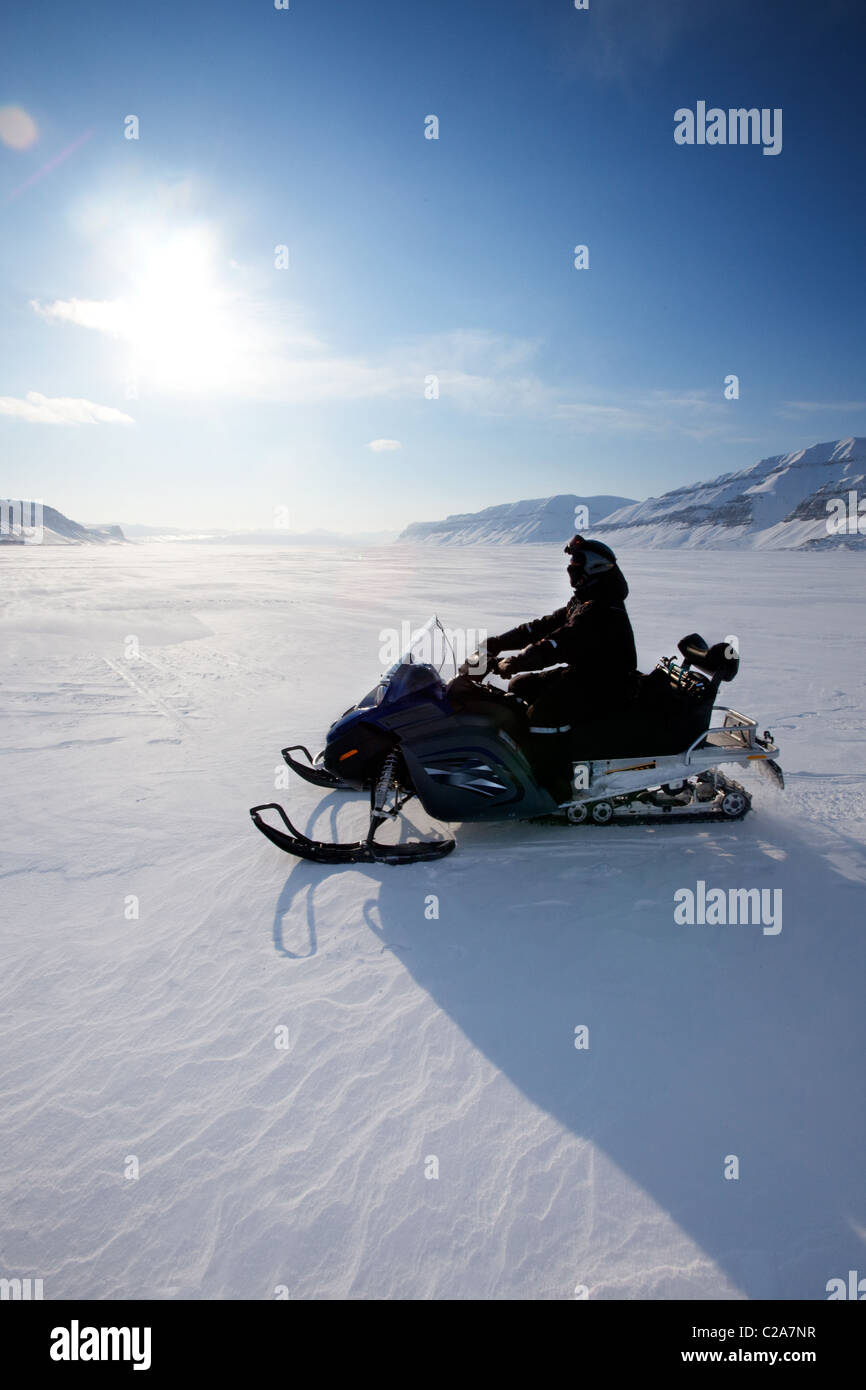 A snowmobile on frozen ice on a barren winter landscape Stock Photo - Alamy