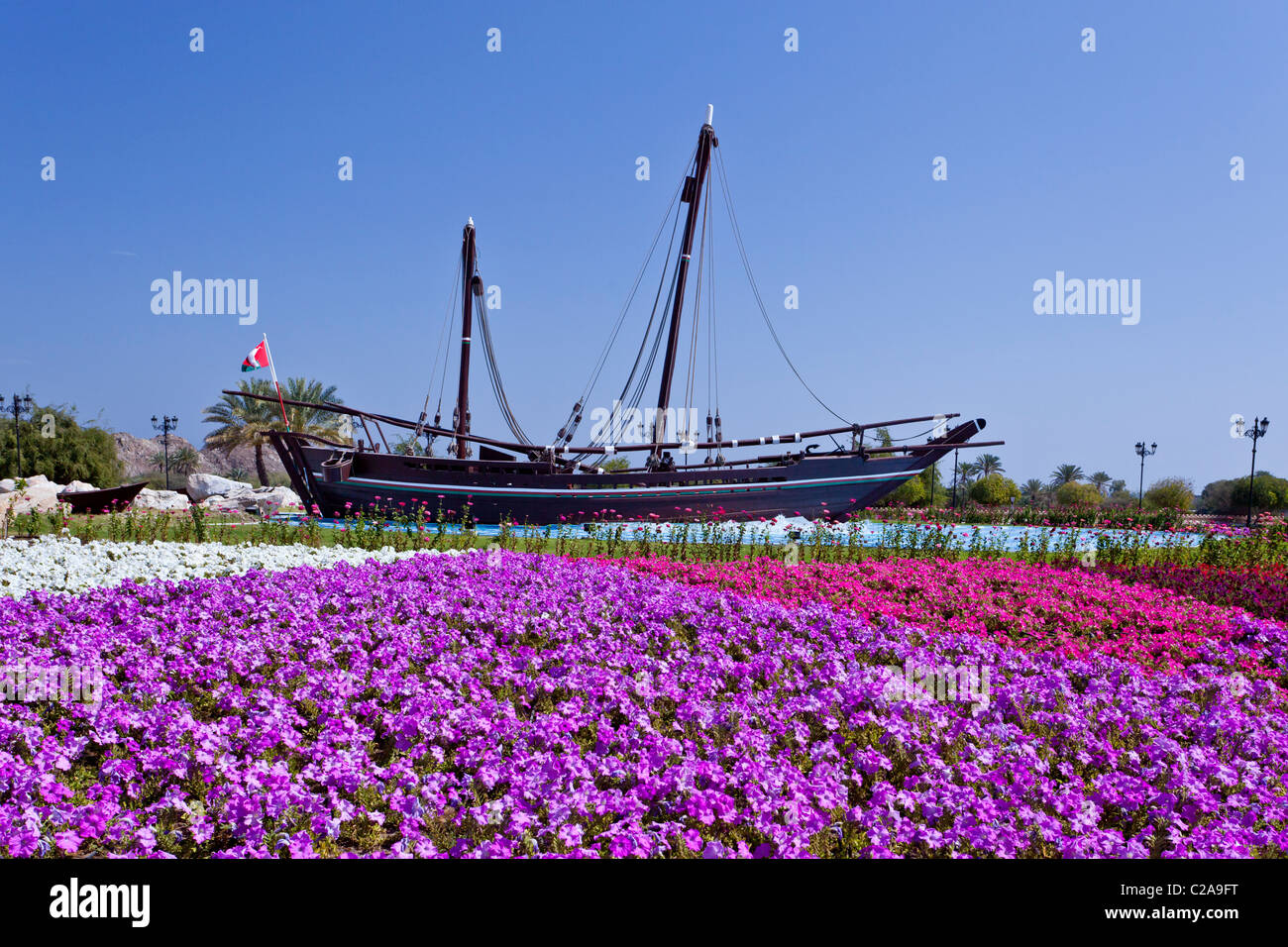 A decorative wooden dow sailing vessel at a roundabout in Muscat, Oman ...