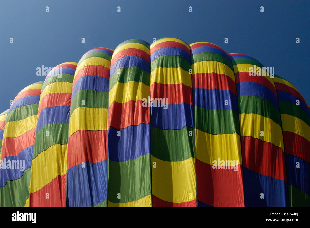 Partly-inflated balloon against a blue sky. The balloon is constructed ...