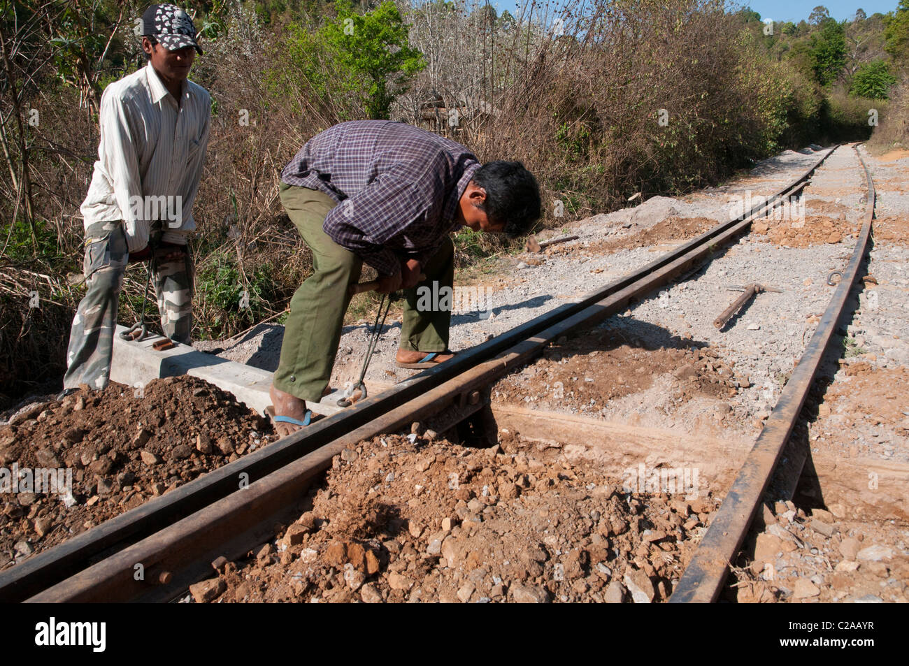 2 men fixing train tracks. Thazi shwenyaung train line. Southern Shan ...
