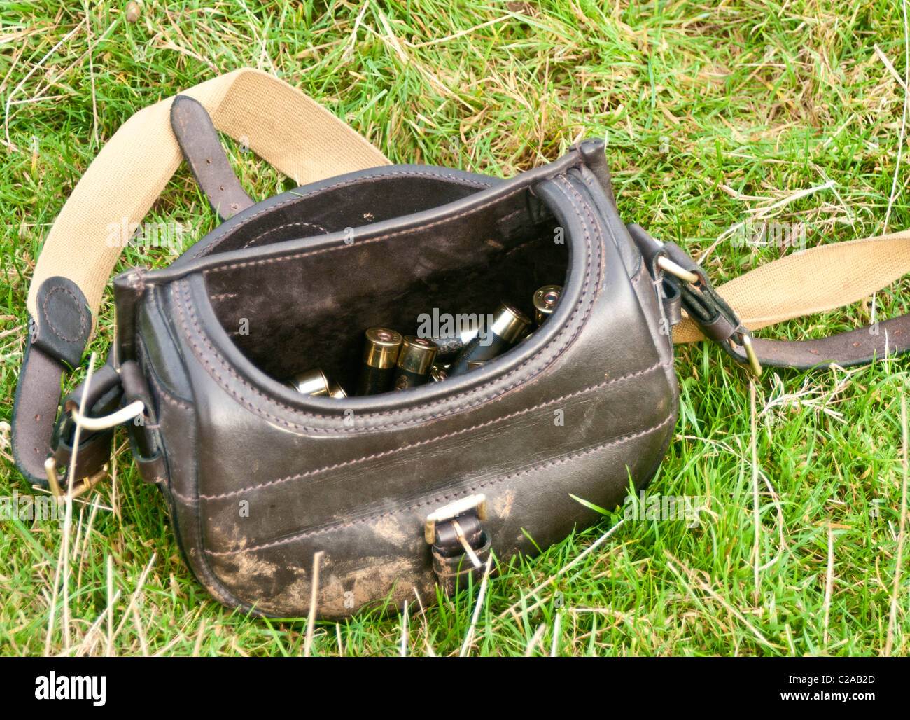 A leather cartridge bag with 12 bore cartridges in on grass Stock Photo ...