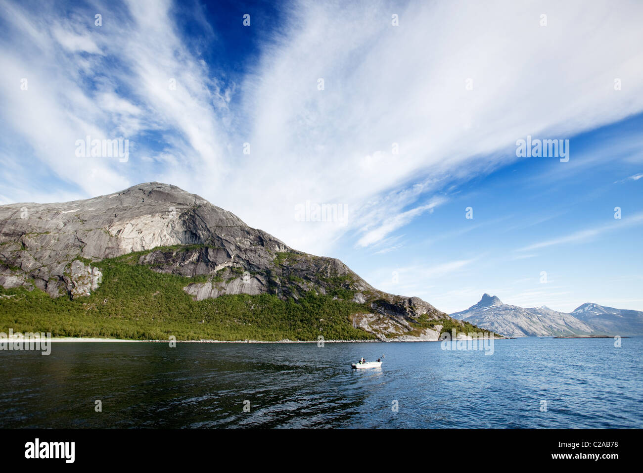 A Norwegian fjord with a small white boat Stock Photo - Alamy