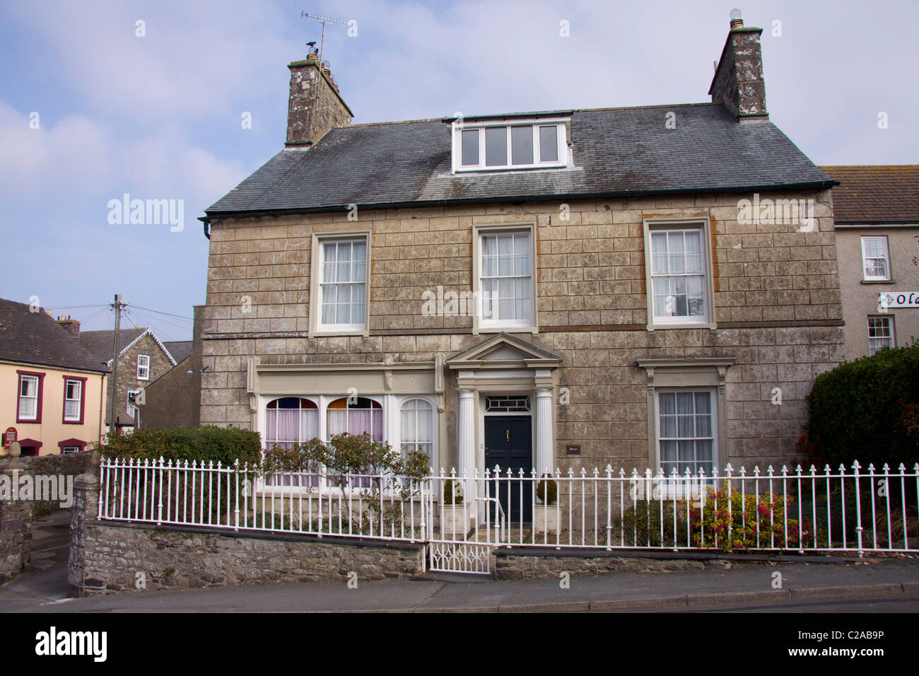 Traditional stone house with slate roof built on a slope, in the square ...