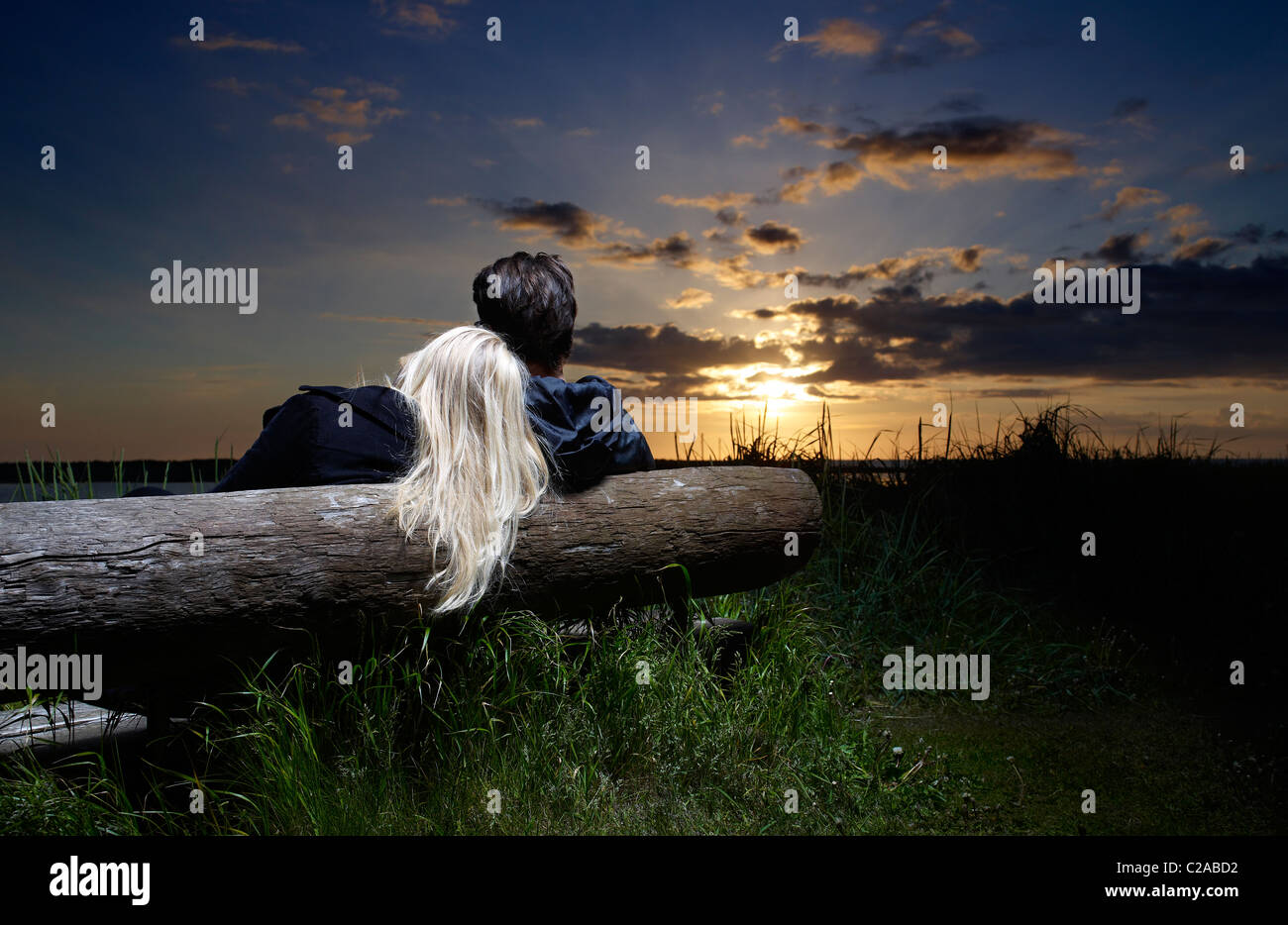 Couple sitting watching sunset hi-res stock photography and images - Alamy