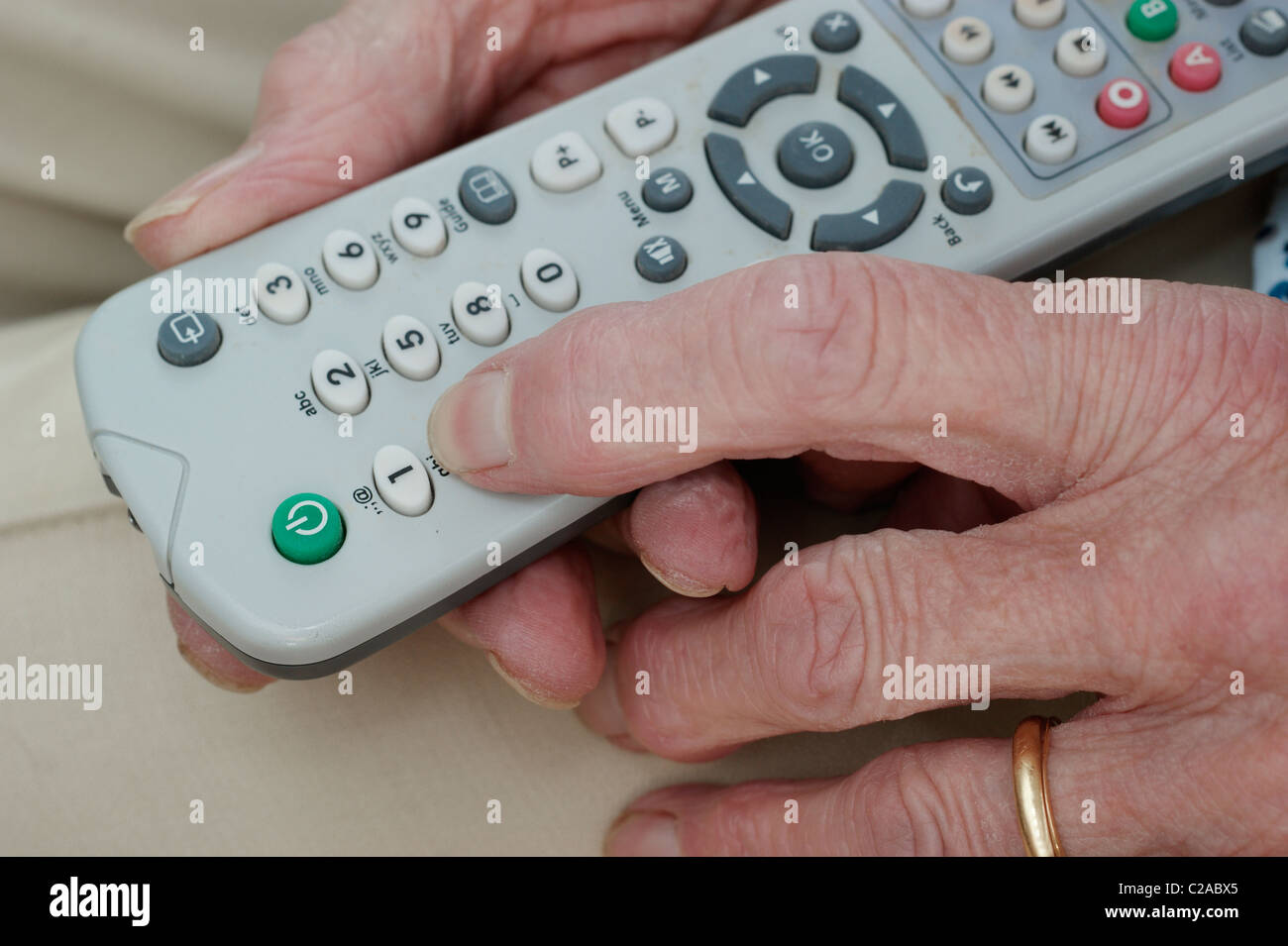 Senior woman changing channels control hi-res stock photography and ...