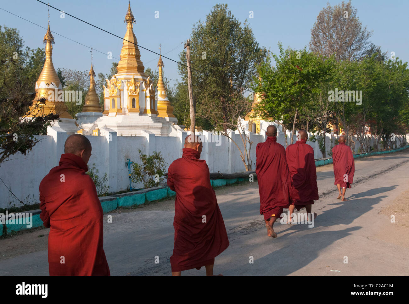 Morning monks procession gathering alms in the streets of Kalaw. Shan ...
