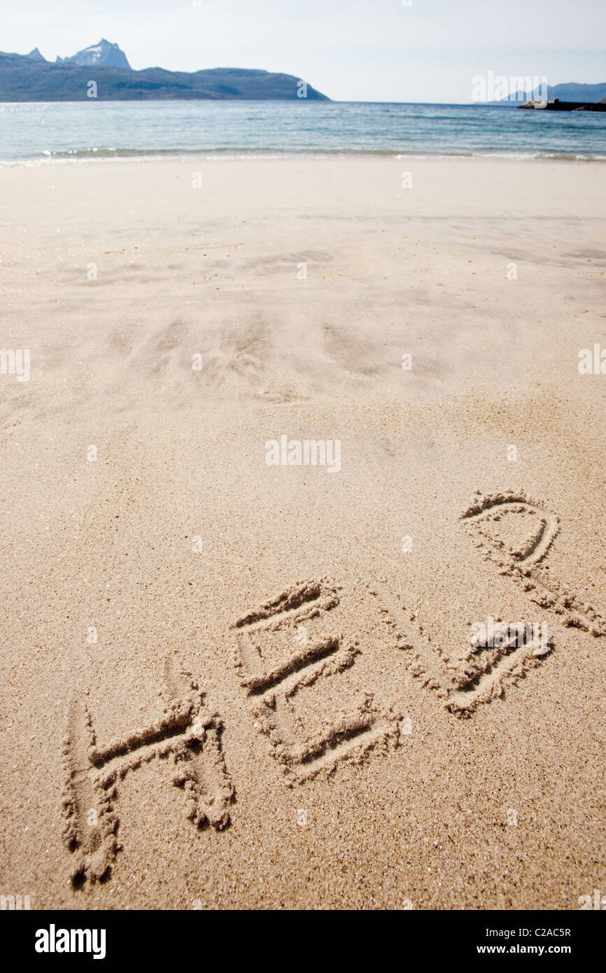 Help written in the sand on a deserted island Stock Photo - Alamy
