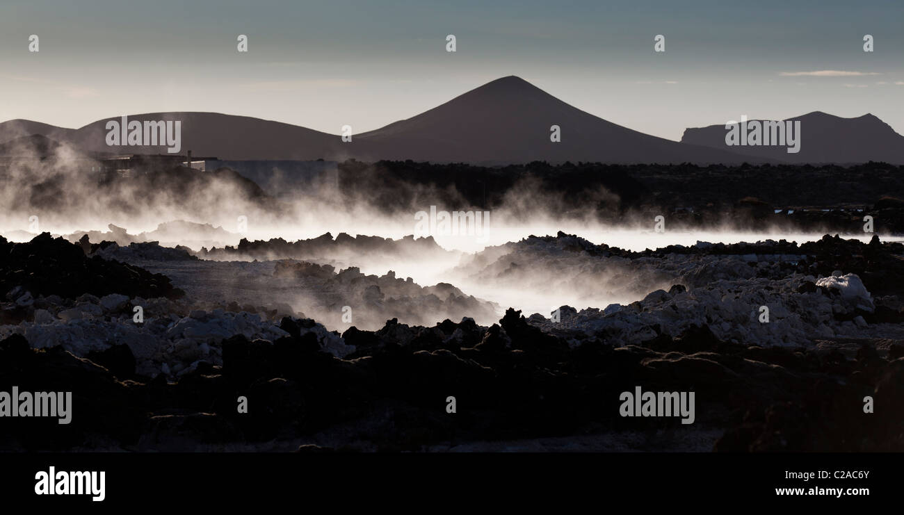 Geothermal steam over lava rocks and water, near The Blue Lagoon ...